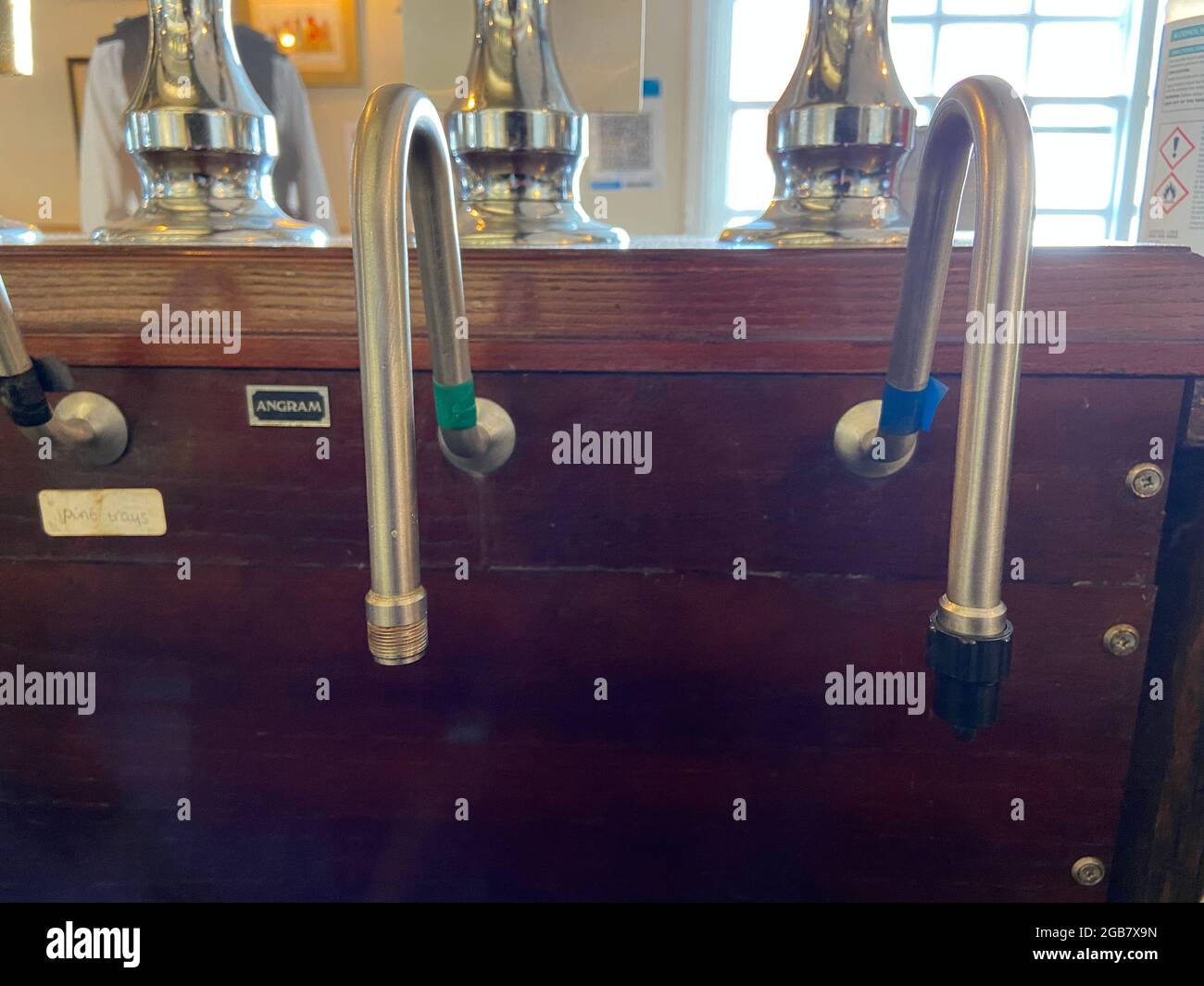 beer taps in pub bar with cleaning spray following covid-19 guidelines ...