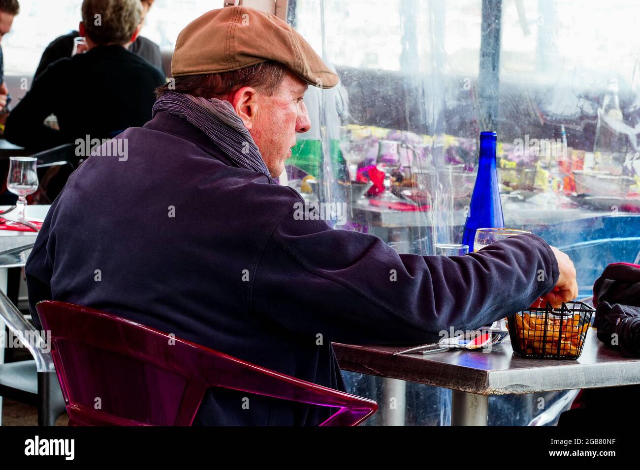 Man in a restaurant eating mussels and fries, Cherbourg, Manche ...