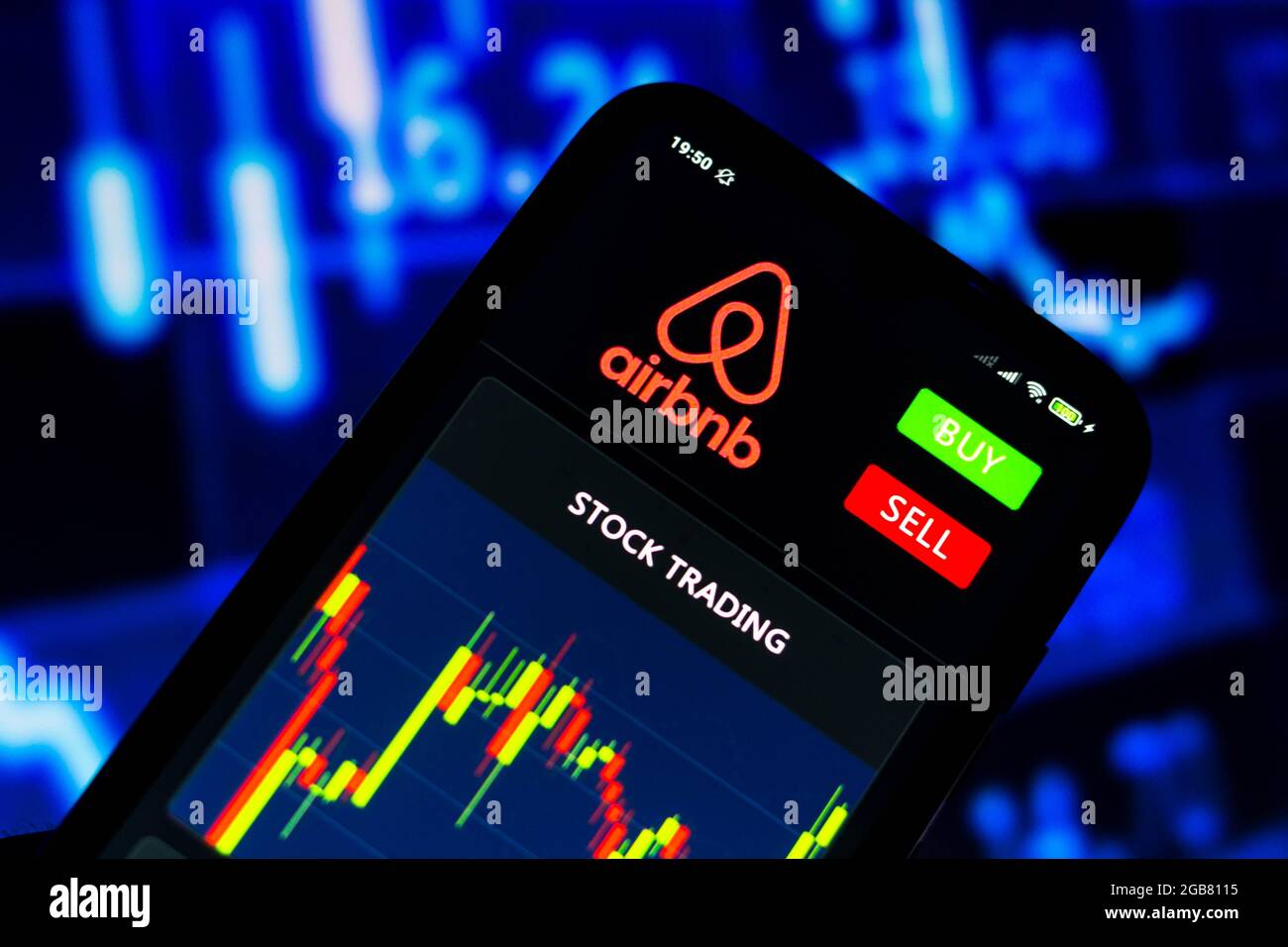In this photo illustration the stock trading graph of Airbnb seen on a ...