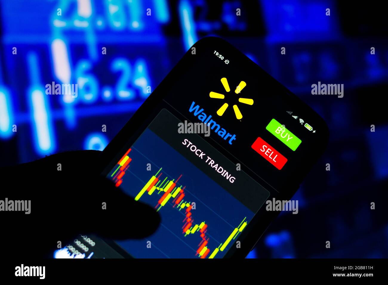 In this photo illustration the stock trading graph of Walmart seen on a ...