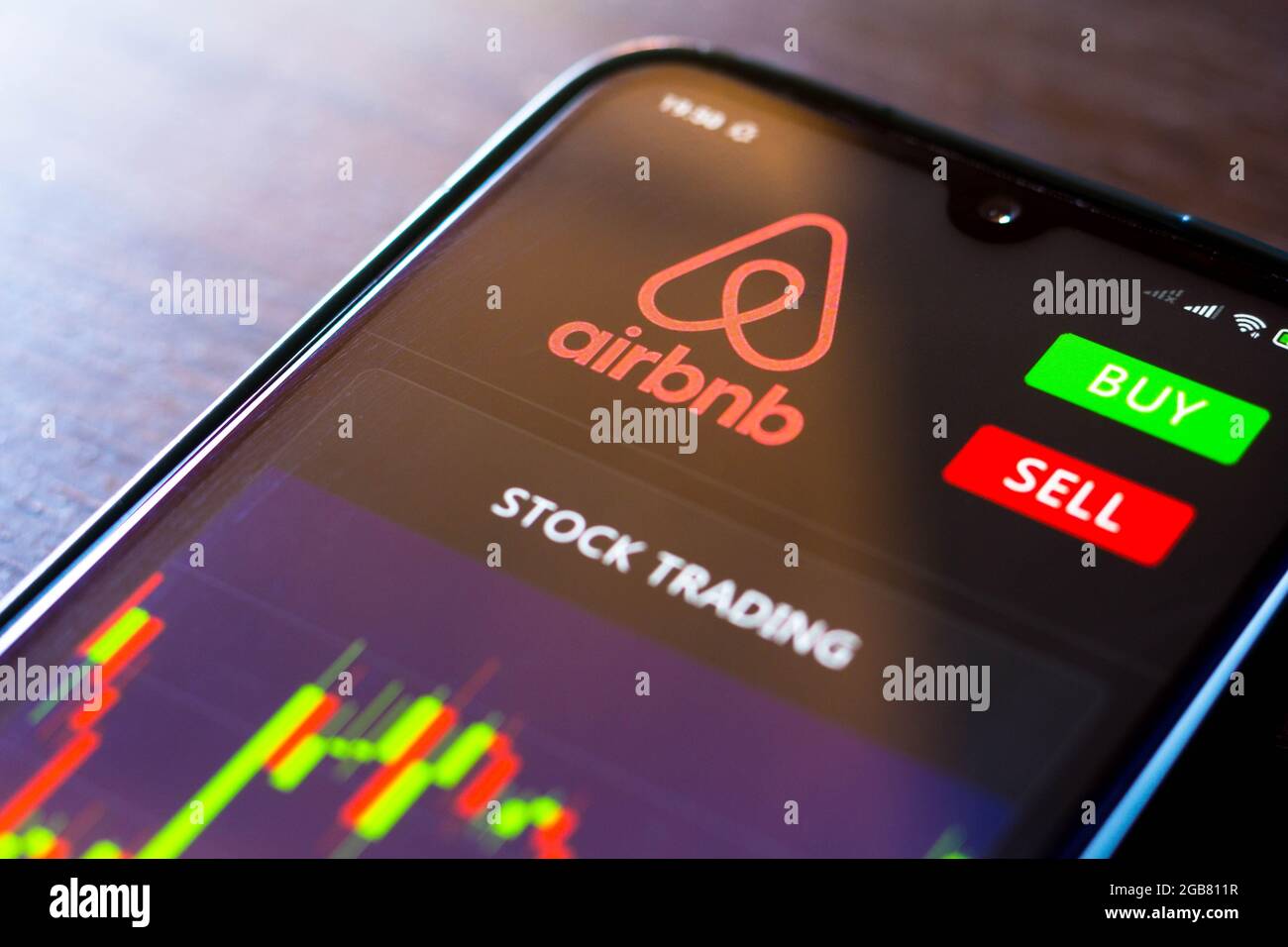 In this photo illustration the stock trading graph of Airbnb seen on a ...