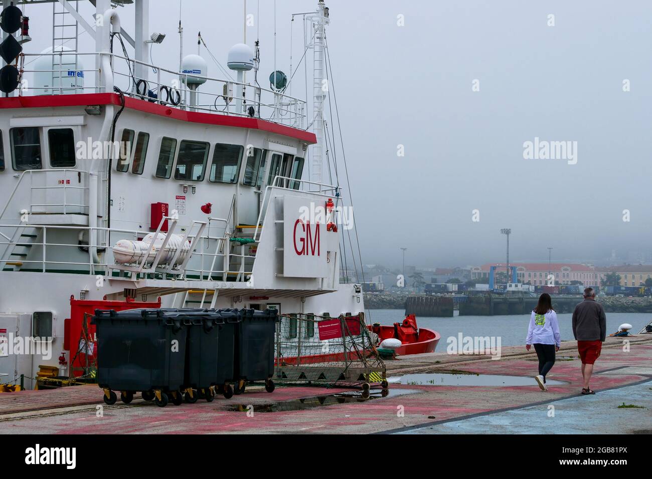 Passers-by on a disused quay, Cherbourg harbor, Manche department ...