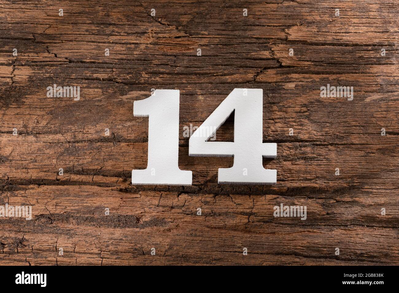 Number fourteen - White Piece on Rustic Wood Background Stock Photo - Alamy