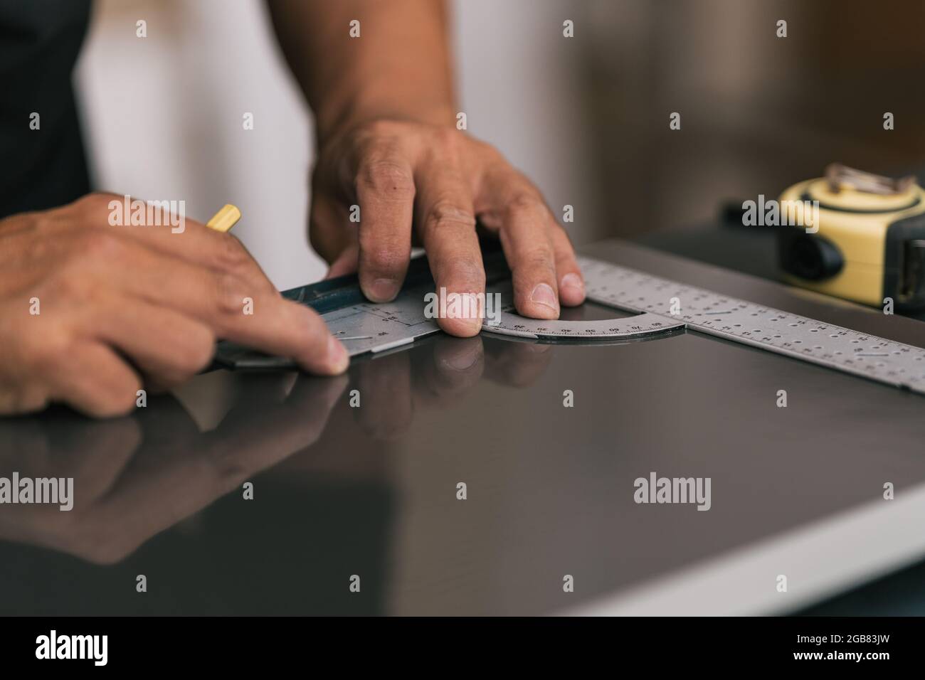 Man using a square in a piece of furniture Stock Photo - Alamy