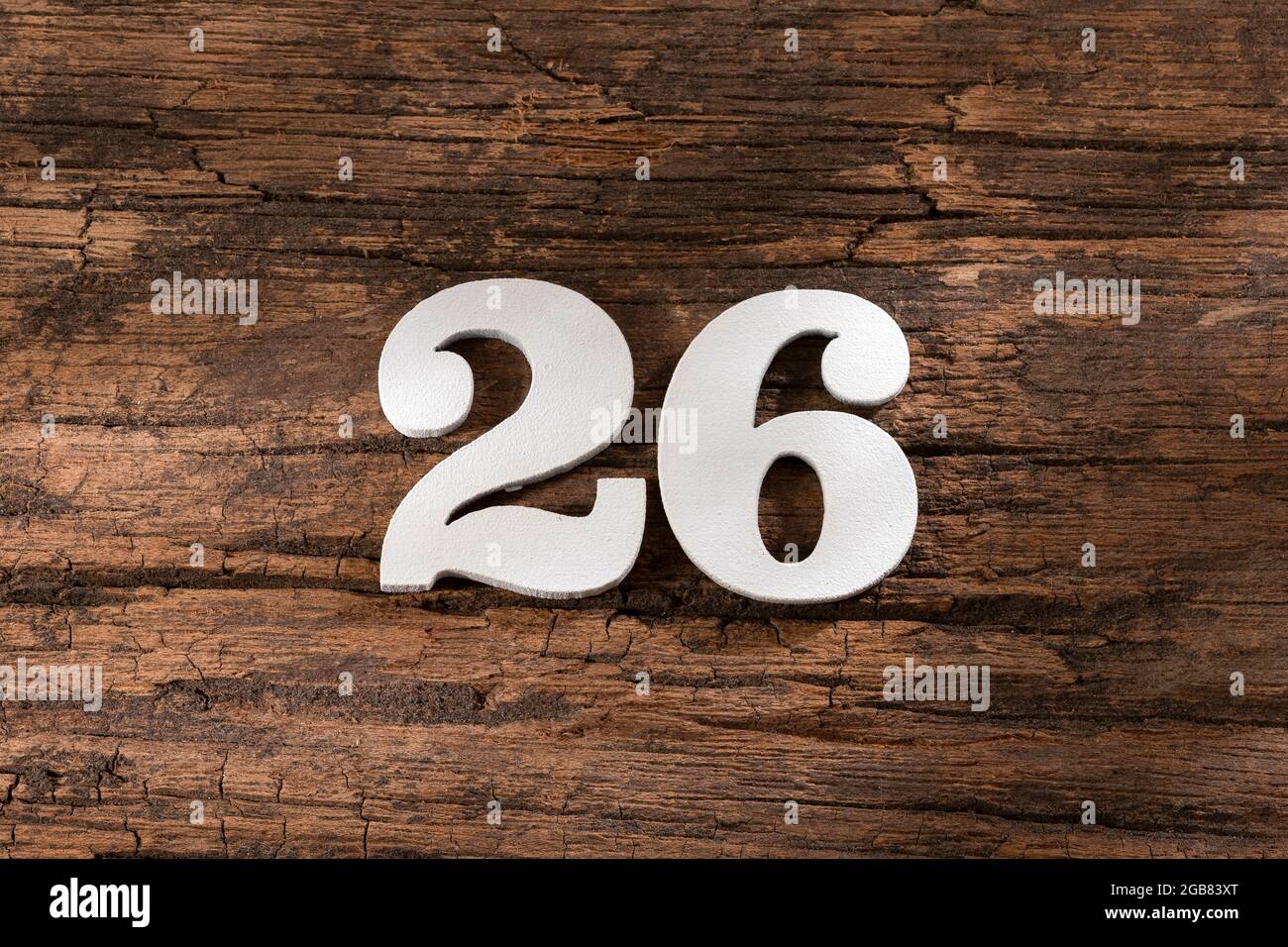 Number twenty six 26 - White Piece on Rustic Wood Background Stock ...