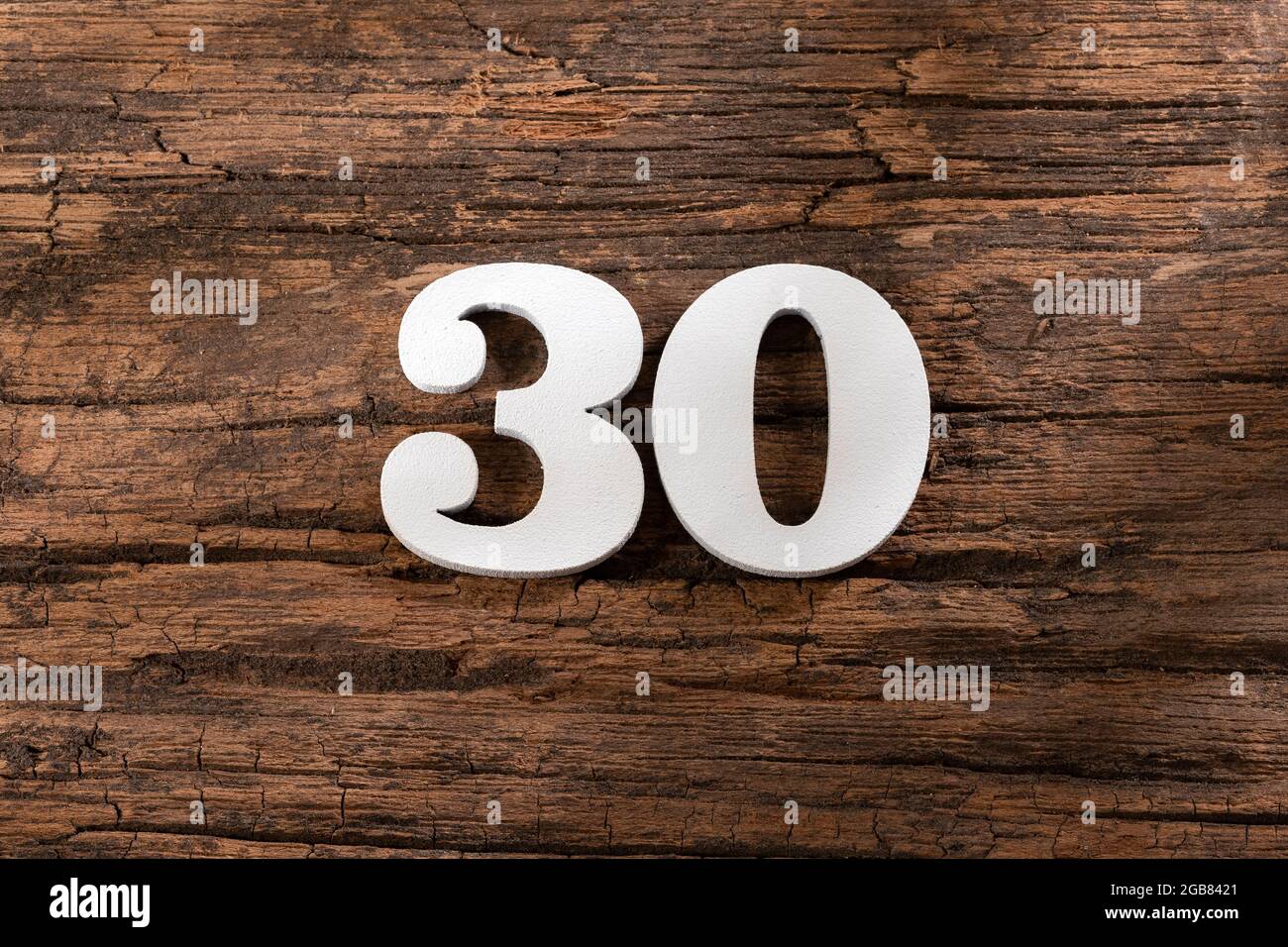 Number thirty 30 - White Piece on Rustic Wood Background Stock Photo ...