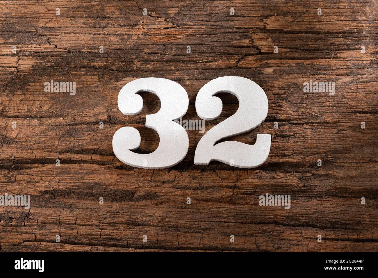 Number thirty two 32 - White Piece on Rustic Wood Background Stock ...