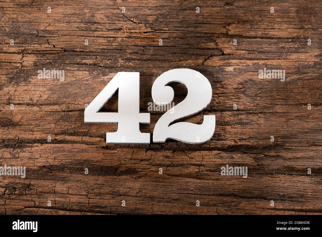 Number forty two 42 - White Piece on Rustic Wood Background Stock Photo ...