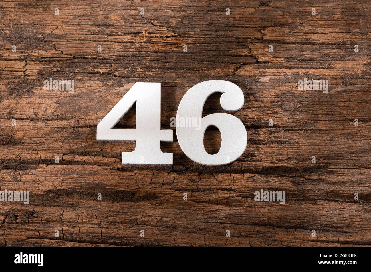 Number forty six 46 - White Piece on Rustic Wood Background Stock Photo ...