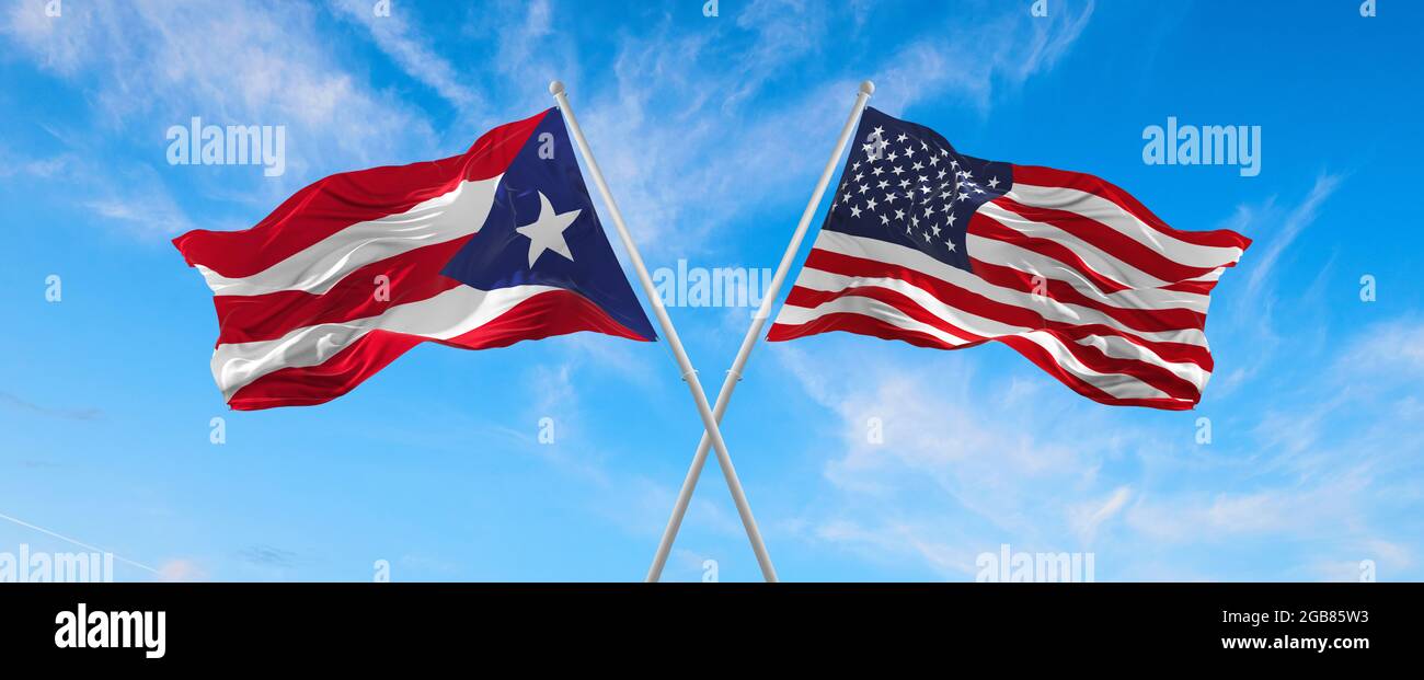 flags of USA and Puerto Rico waving in the wind on flagpoles against ...