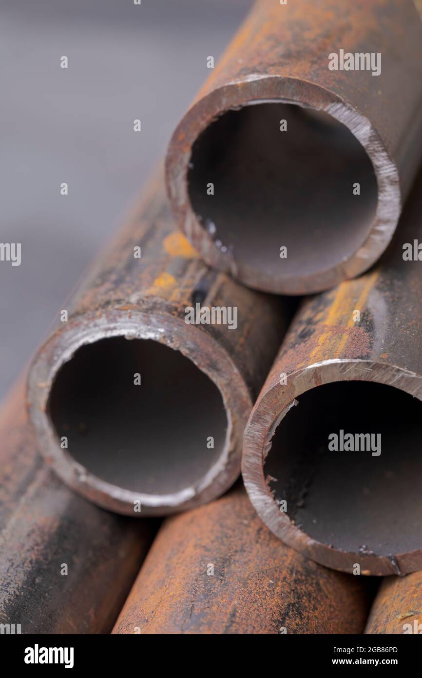 Background of fragments of rusted metal pipes close-up. Industrial ...