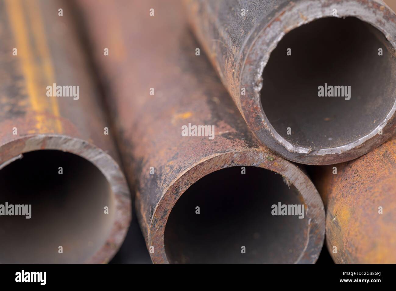 Background of fragments of rusted metal pipes close-up. Industrial ...