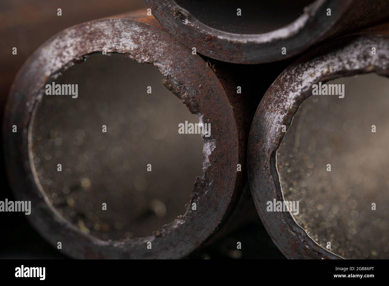 Background of fragments of rusted metal pipes close-up. Industrial ...