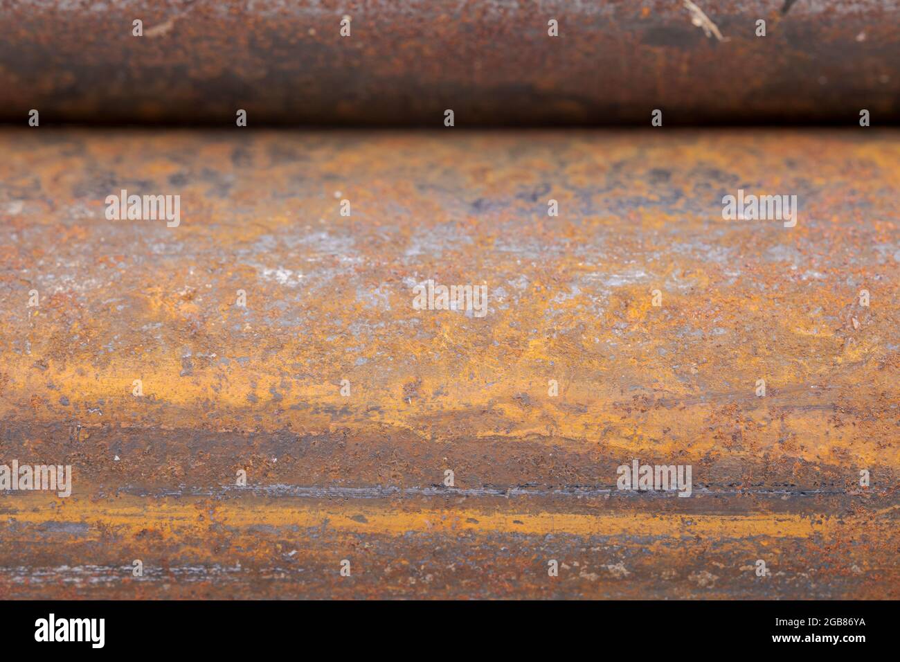 Background of fragments of rusted metal pipes close-up. Industrial ...