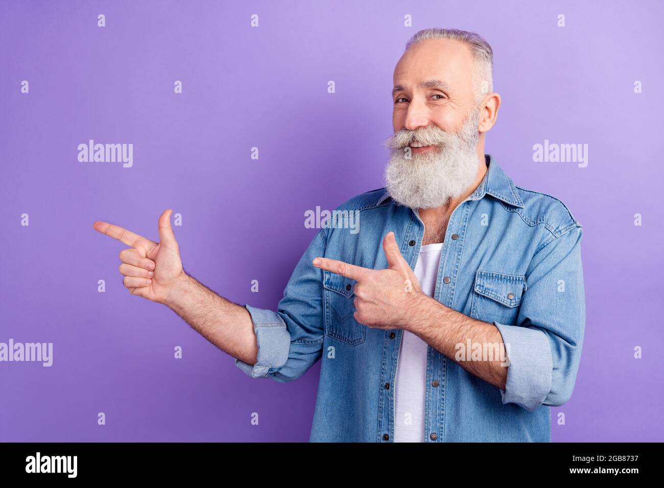 Photo of cheerful positive age gentleman wear jeans shirt pointing two ...
