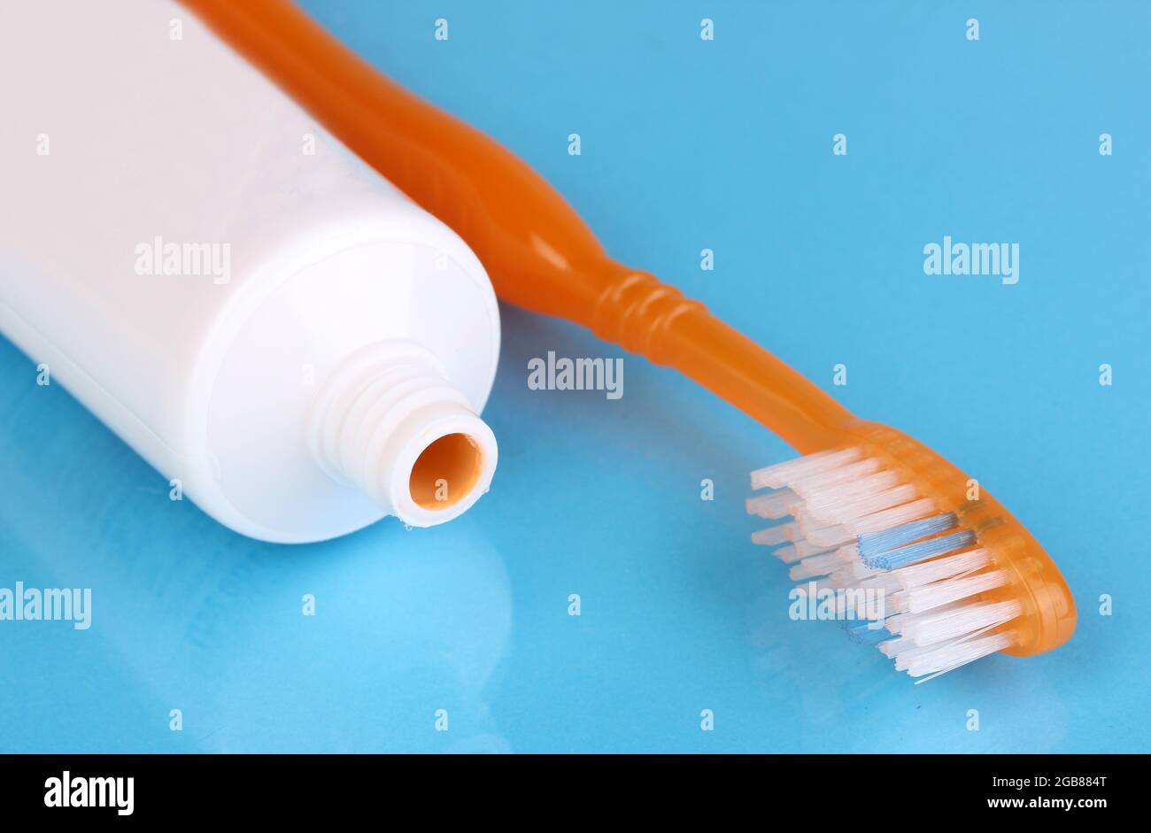 Toothbrush and paste on blue background Stock Photo - Alamy