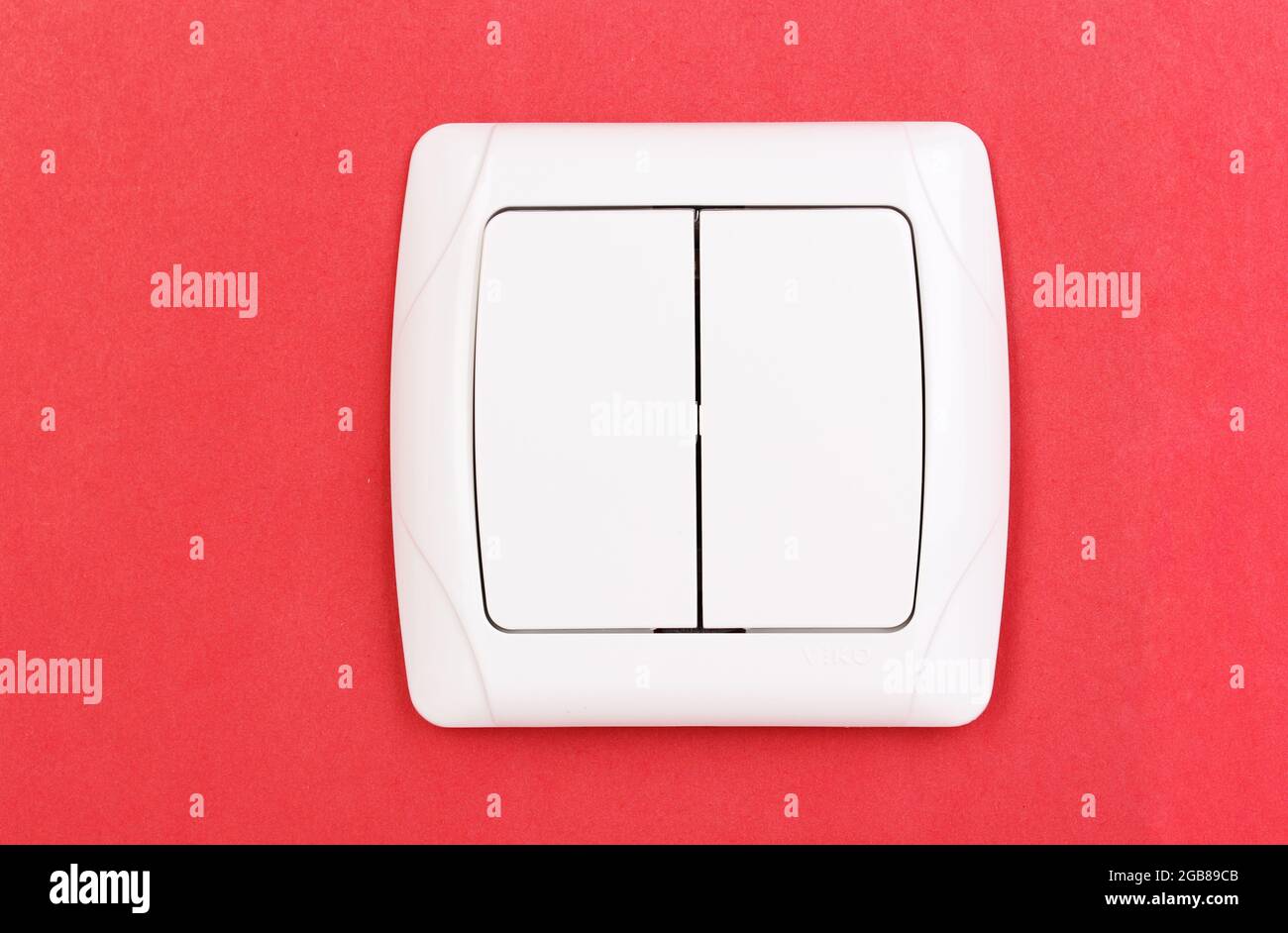 Modern light switch on red background Stock Photo - Alamy