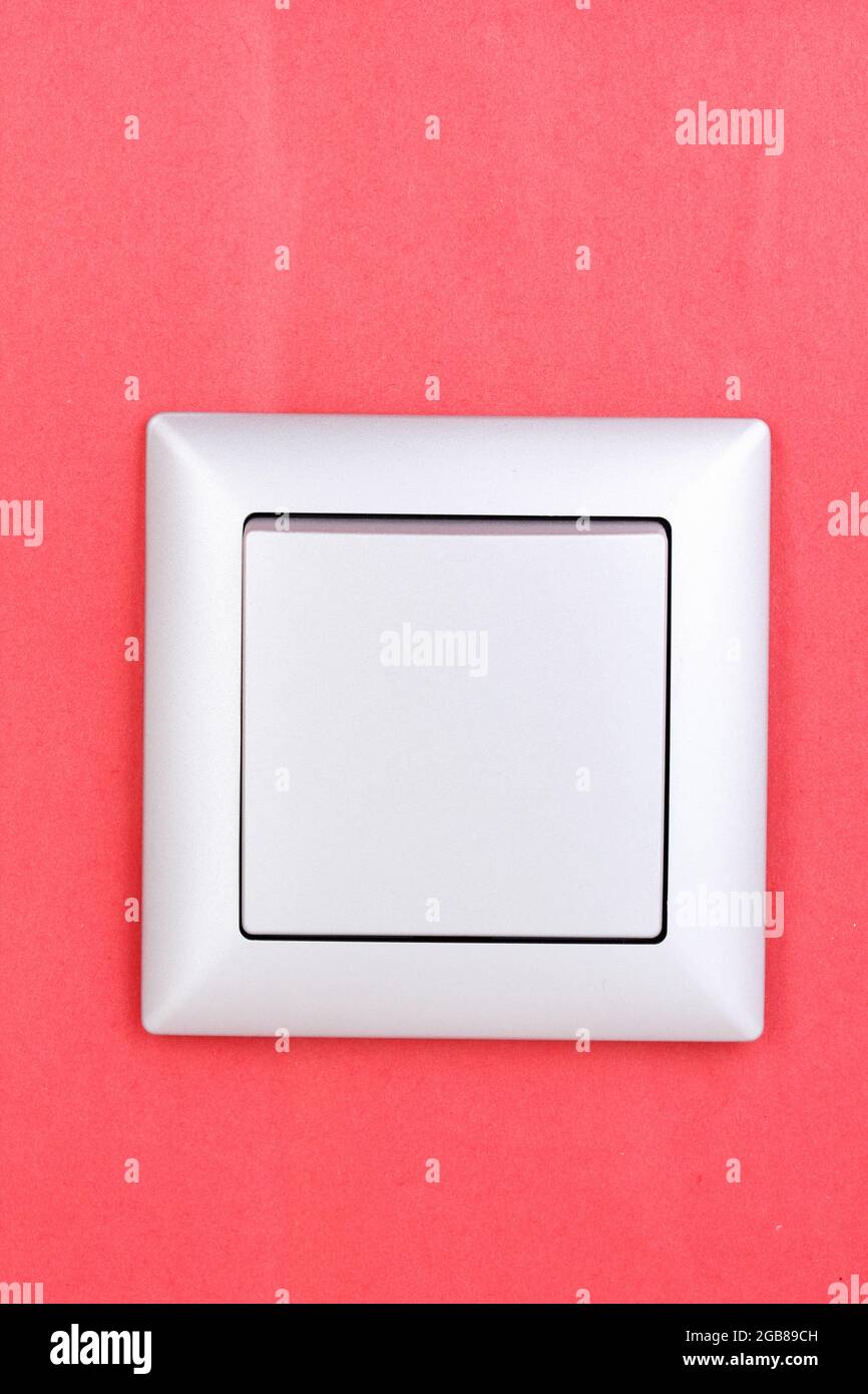 Modern light switch on red background Stock Photo - Alamy