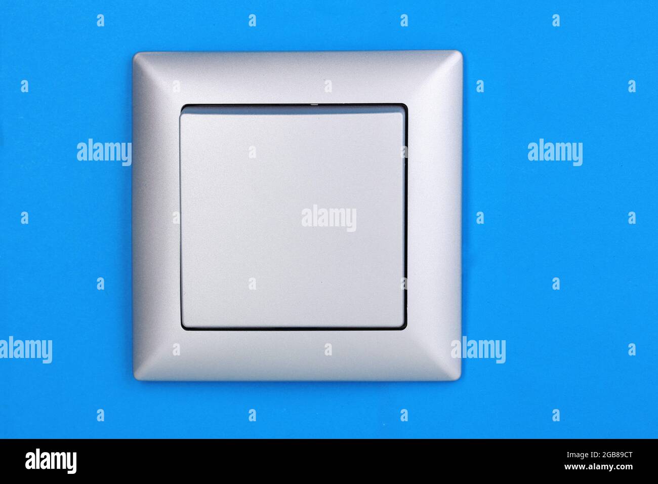 Modern light switch on blue background Stock Photo - Alamy
