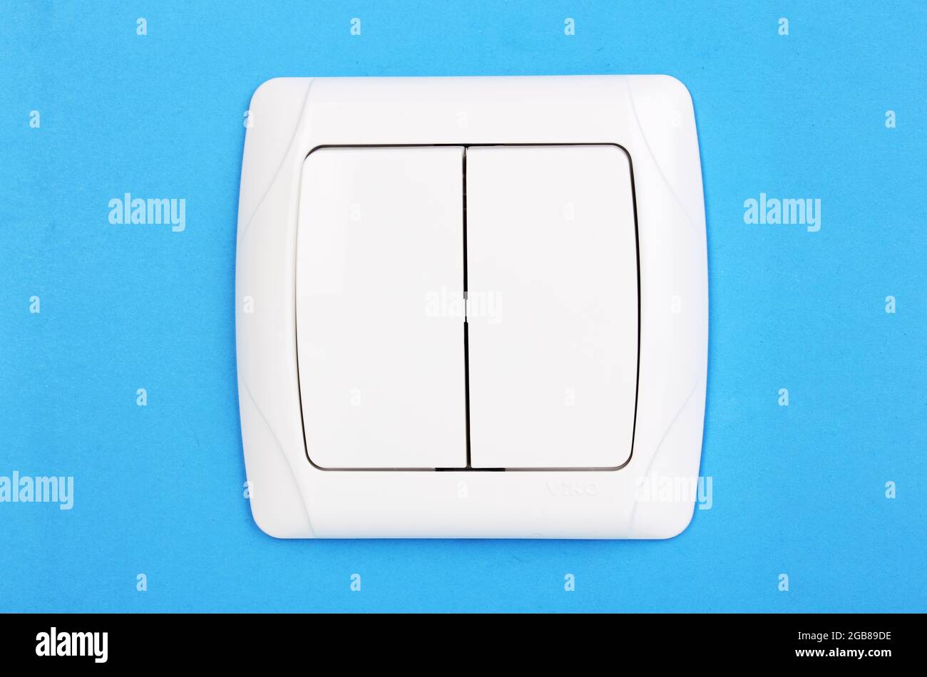 Modern light switch on blue background Stock Photo - Alamy