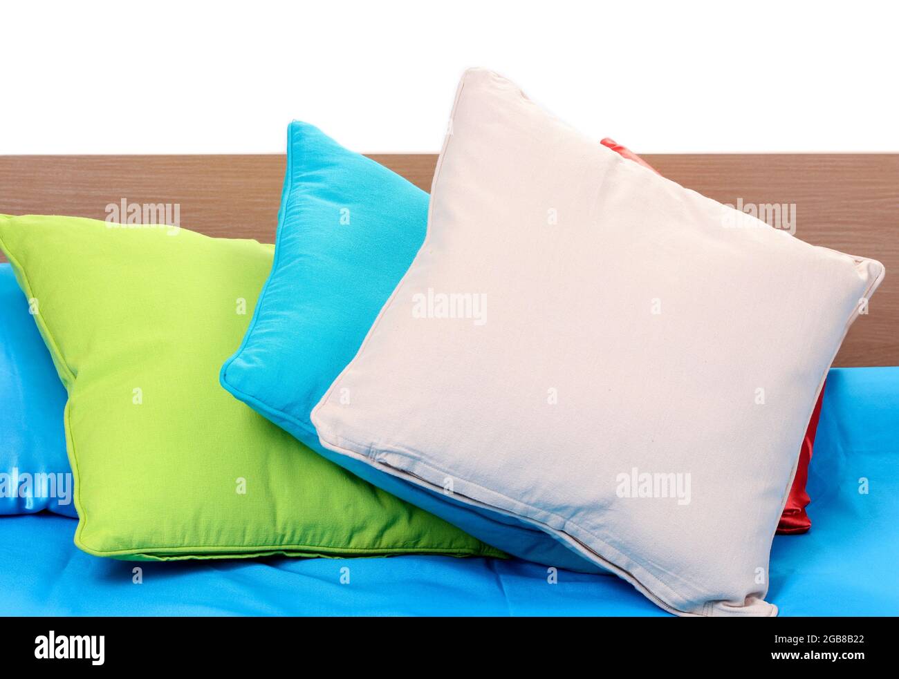 bright pillows on bed on white background Stock Photo - Alamy