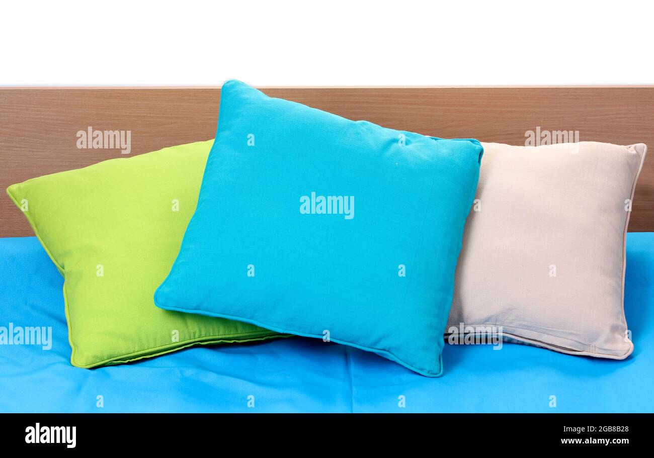 bright pillows on bed on white background Stock Photo - Alamy