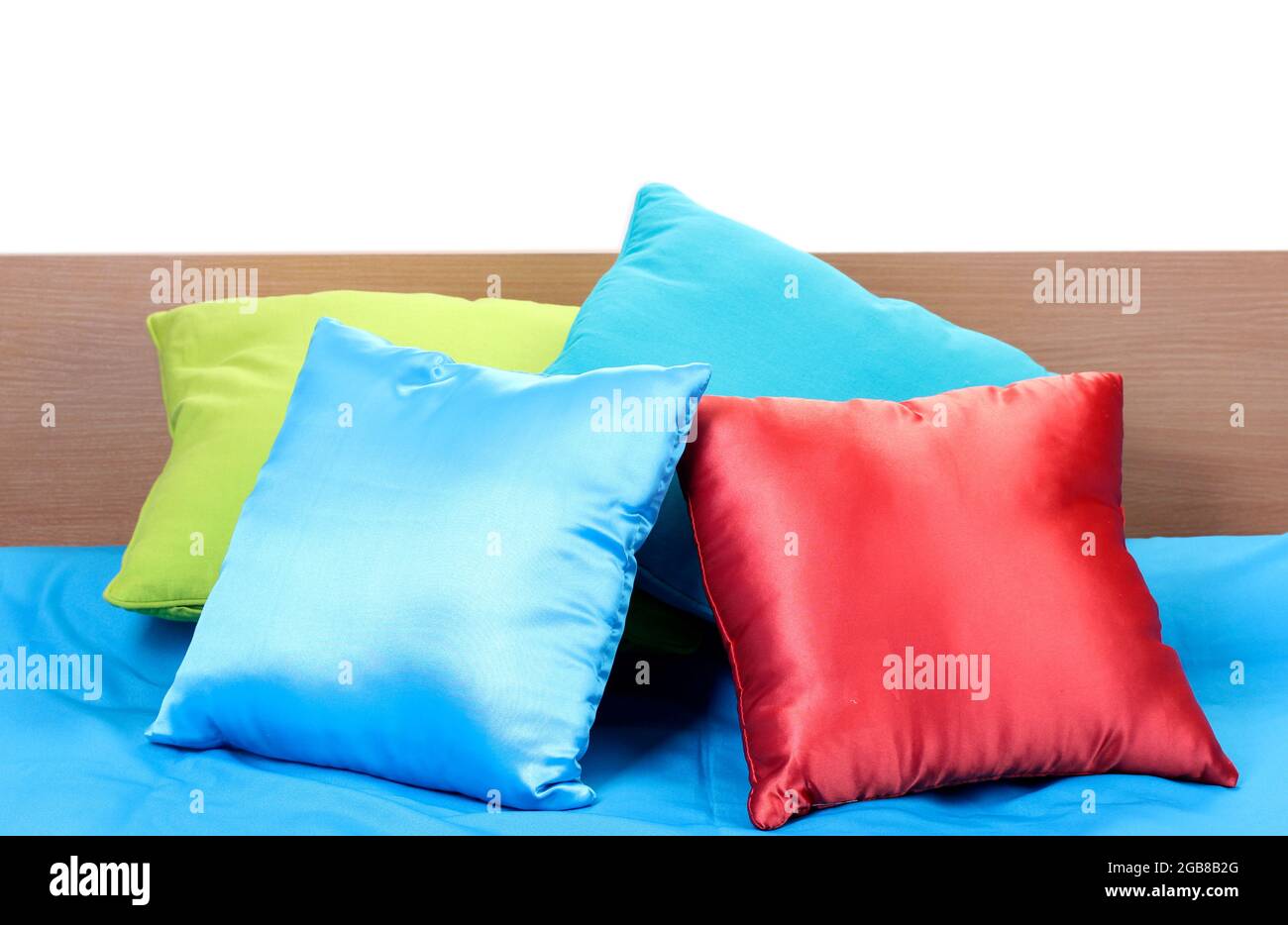 bright pillows on bed on white background Stock Photo - Alamy
