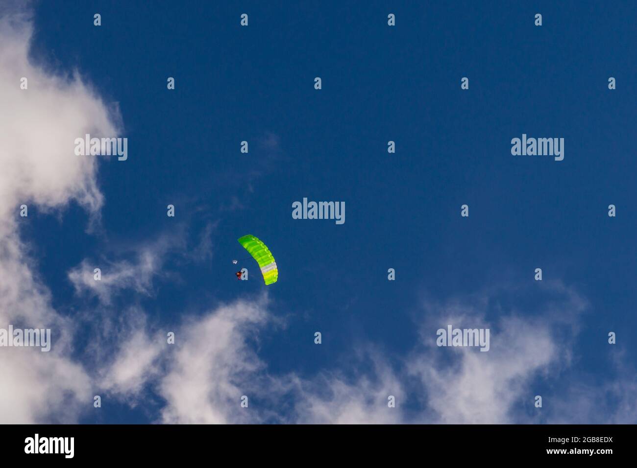 green parachute against the background of blue sky and clouds Stock ...