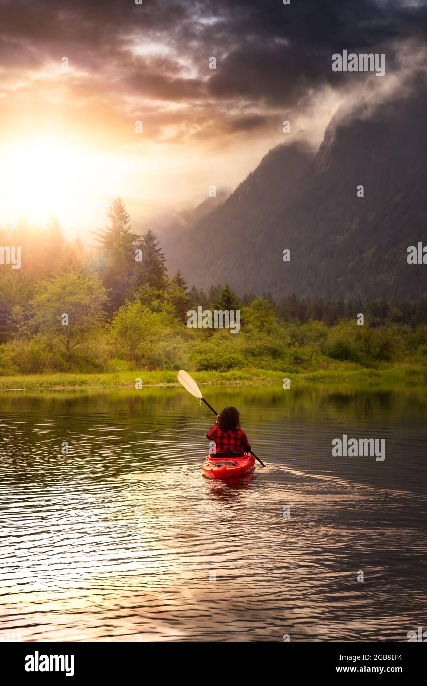 Adventure Caucasian Adult Woman Kayaking in Red Kayak Stock Photo - Alamy