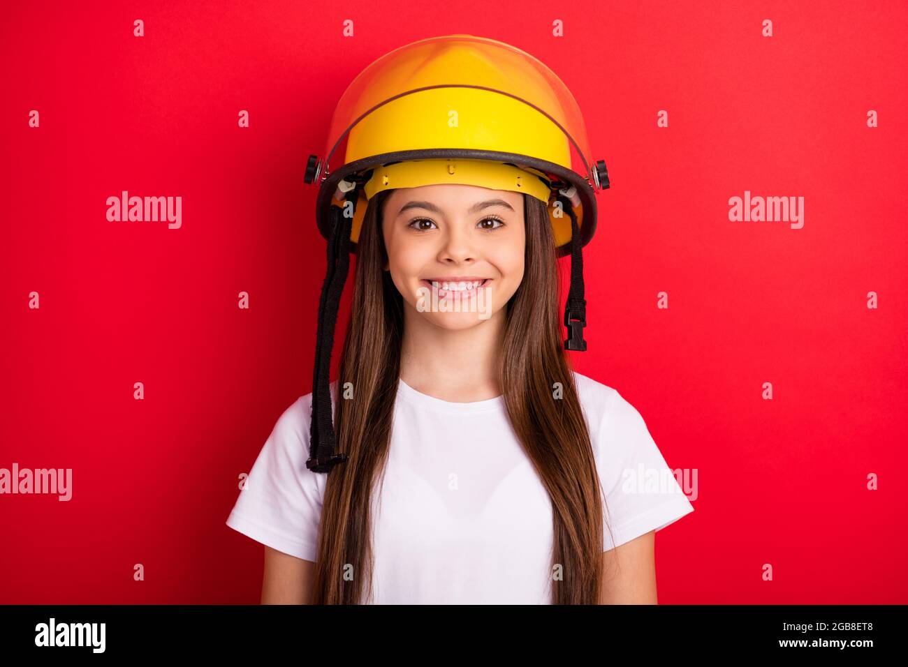 Photo of young girl happy positive smile wear helmet firefighter ...