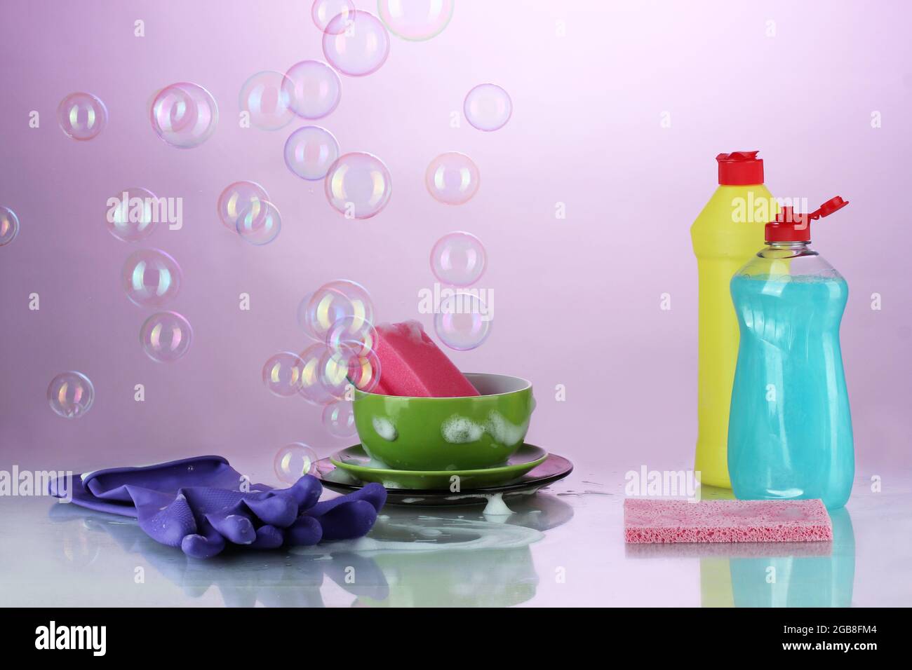 Washing dishes. Cleaning products on bright violet background Stock ...