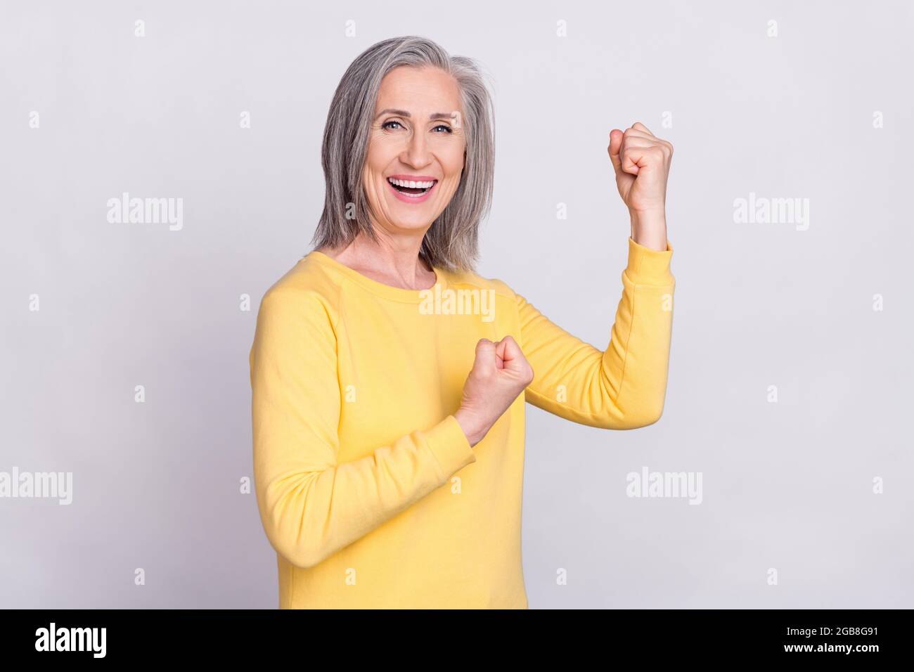 Photo Of Happy Excited Good Mood Cheerful Mature Woman Raise Fists In