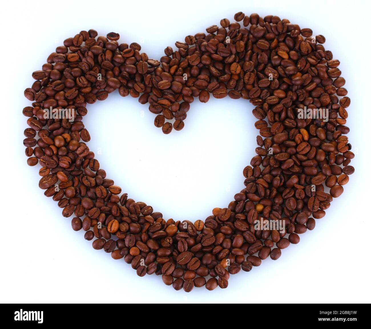 Heart of coffee beans isolated on white Stock Photo - Alamy