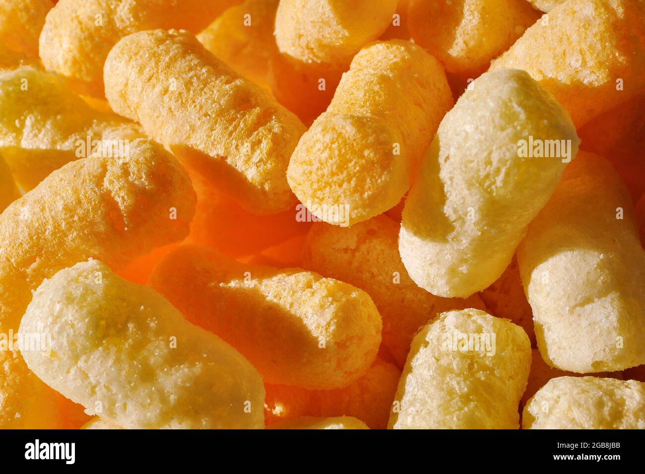 Closeup of puffcorn under sunlight. Sweet snack corn puffs. Macro of ...