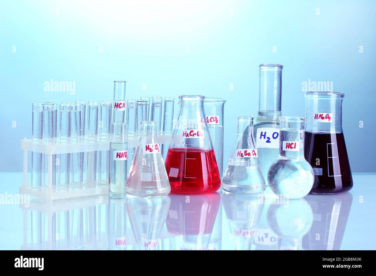 Test-tubes with various acids on blue background Stock Photo - Alamy