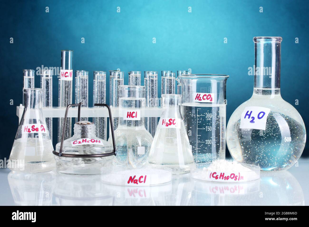 Test-tubes with various acids and chemicals on bright background Stock ...