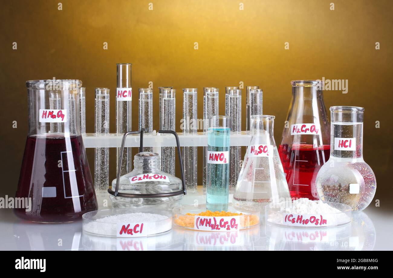 Test-tubes with various acids and chemicals on bright background Stock ...