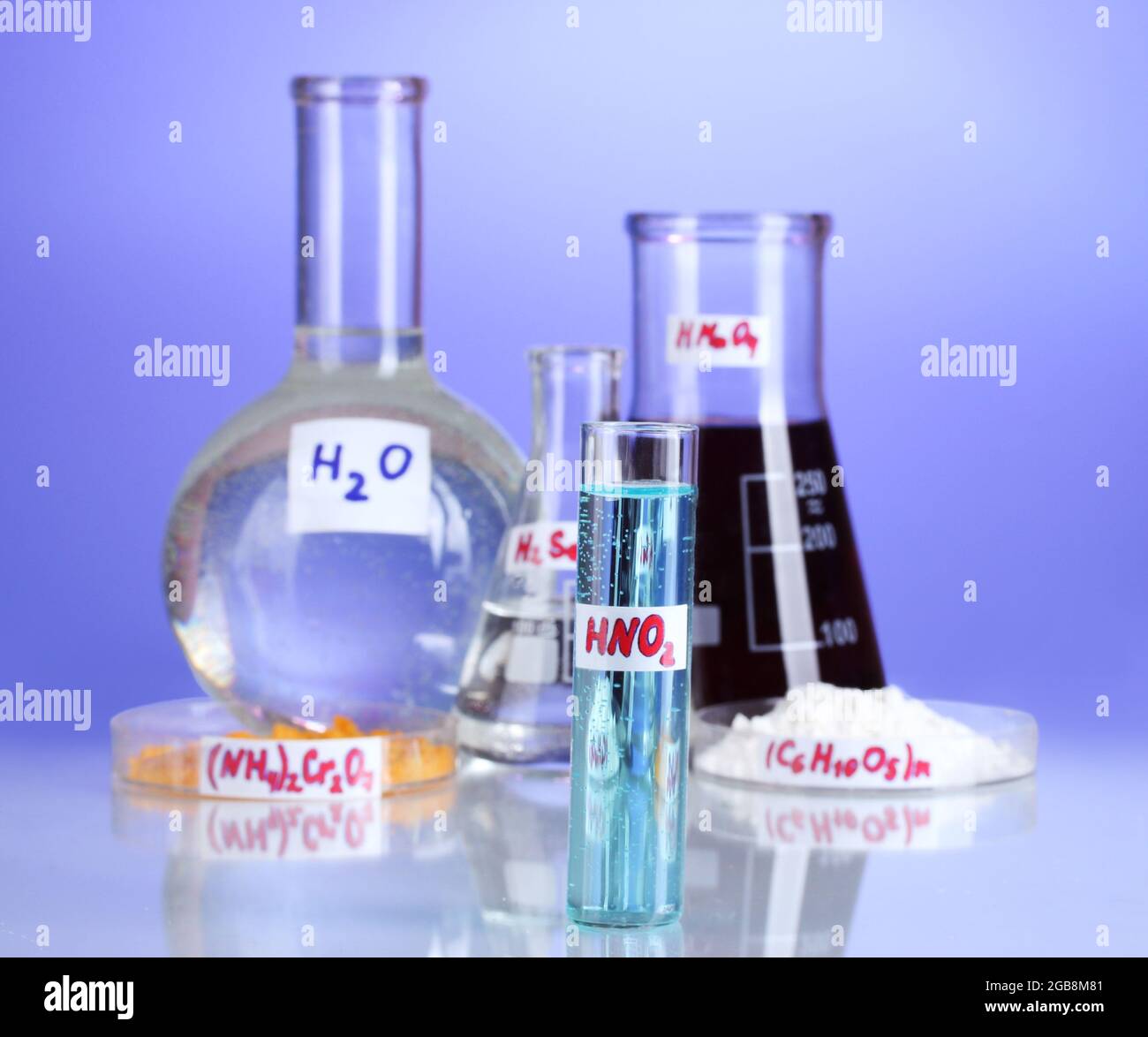 Test-tubes with various acids and chemicals on violet background Stock ...