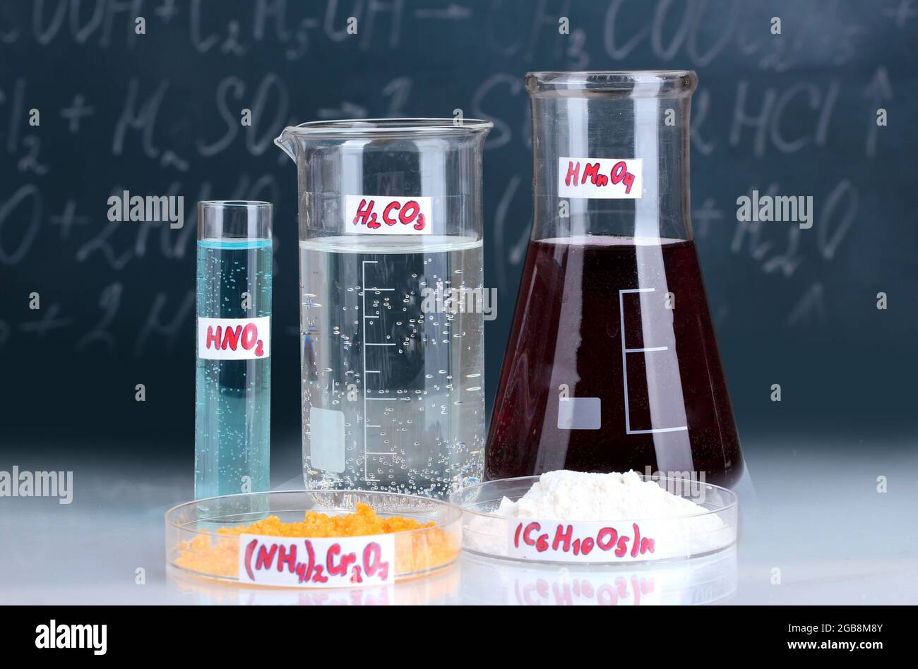 Test-tubes with various acids and other chemicals on the background of ...