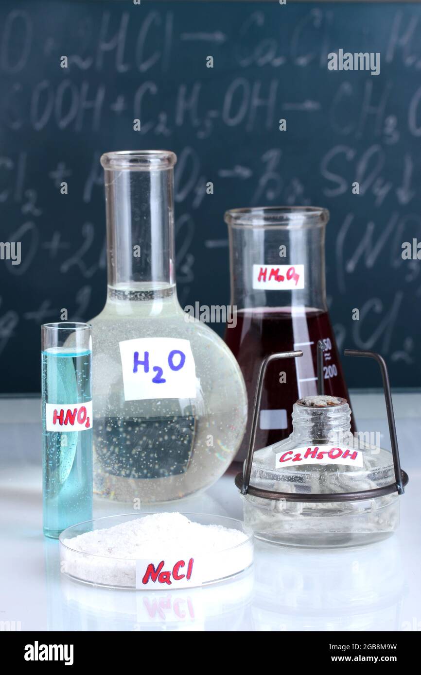 Test-tubes with various acids and other chemicals on the background of ...