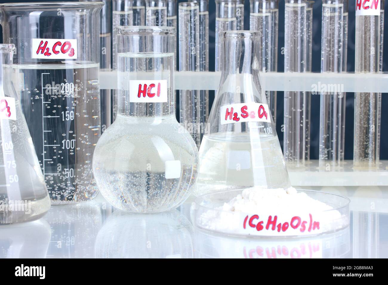 Test-tubes with various acids and other chemicals on the background of ...