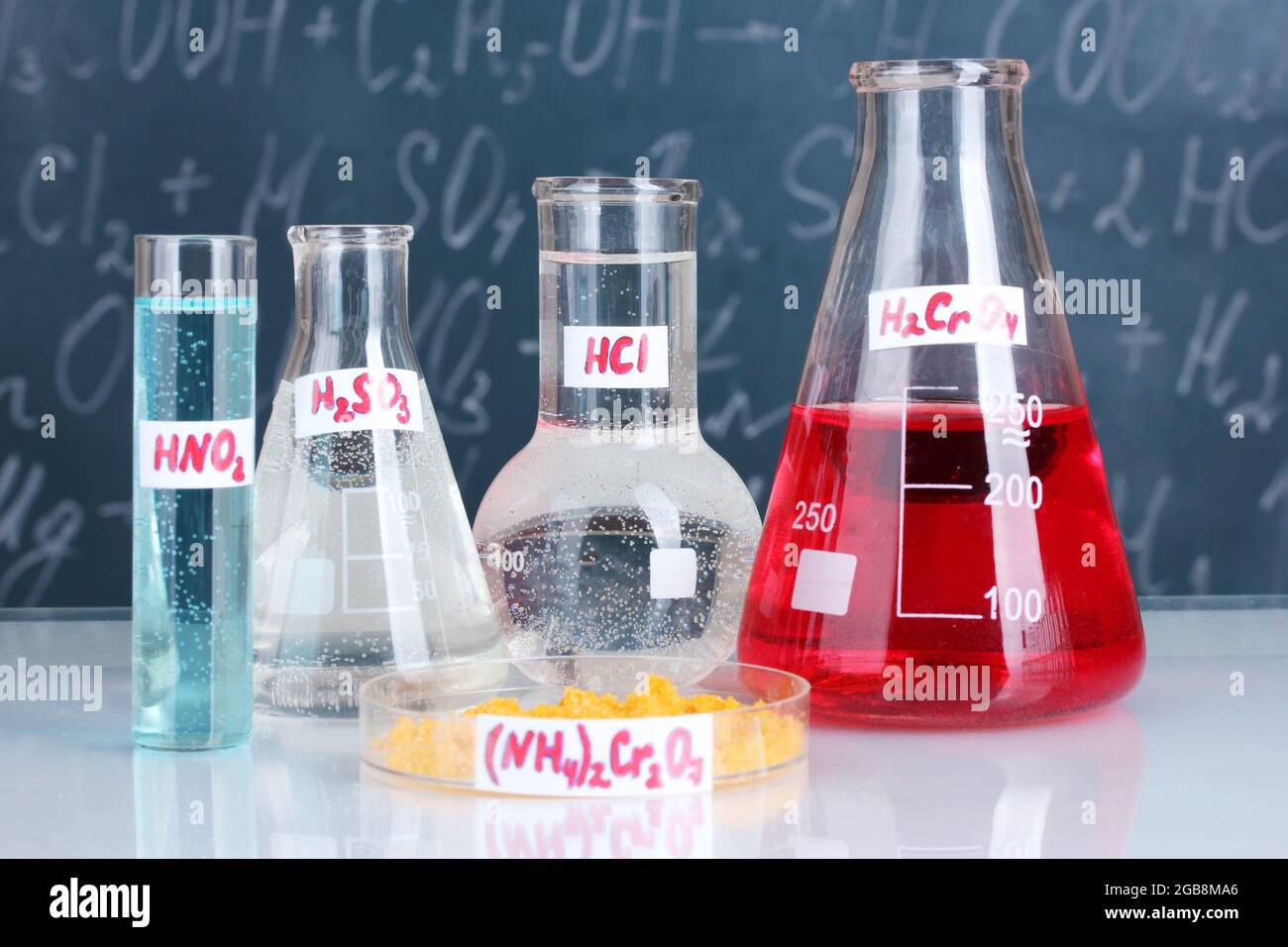 Test-tubes with various acids and other chemicals on the background of ...
