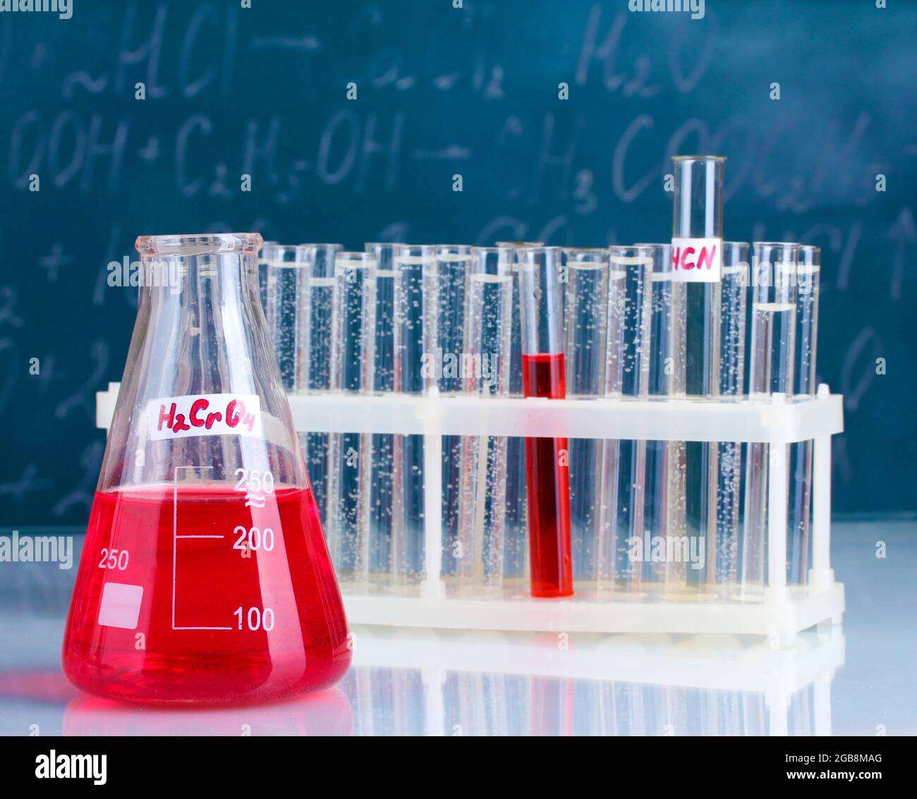 Test-tubes with various acids and other chemicals on the background of ...
