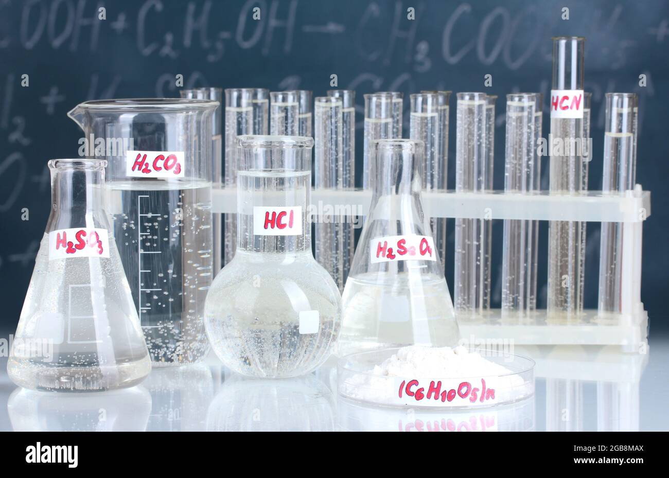 Test-tubes with various acids and other chemicals on the background of ...