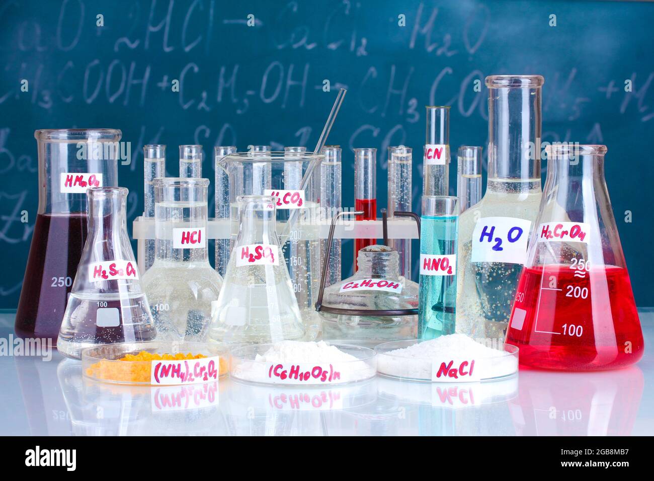 Test-tubes with various acids and other chemicals on the background of ...