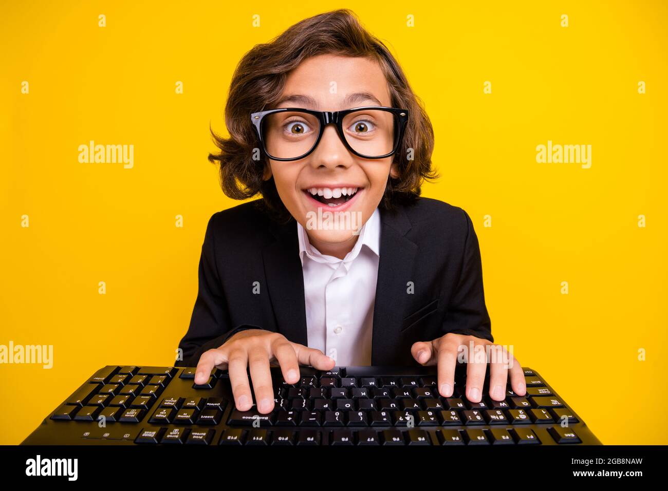 Photo of funny boy typing keyboard look webcamera wear specs black ...