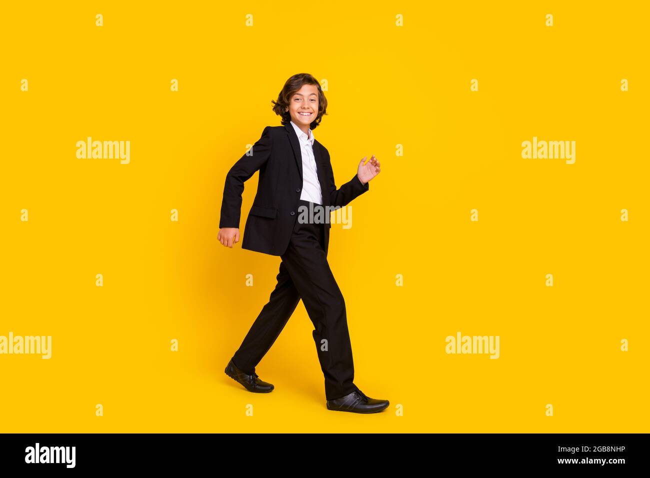 Photo of funny cheerful little boy enjoy walk shiny smile wear black ...