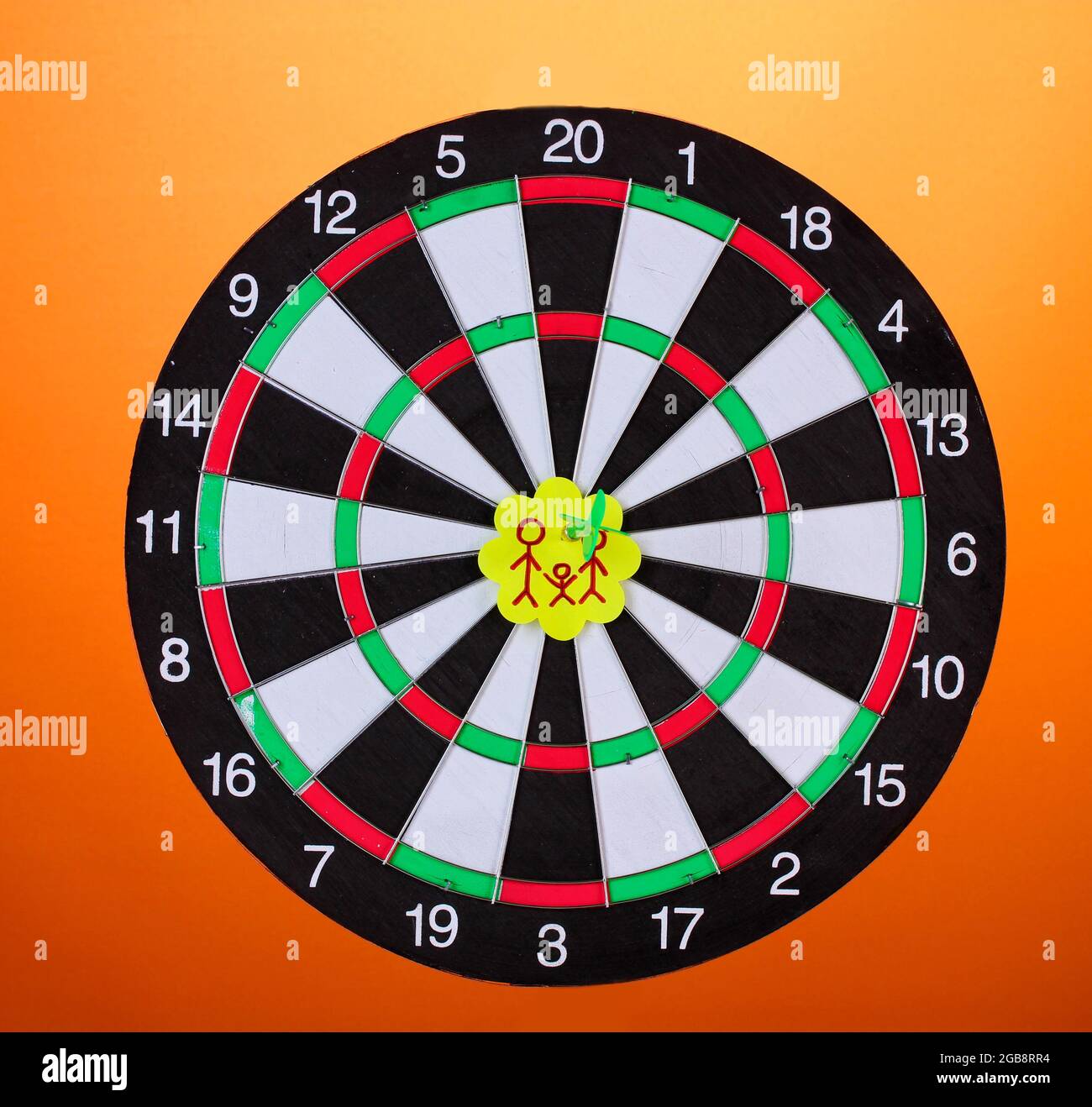 Darts with stickers depicting the life values on colorful background ...