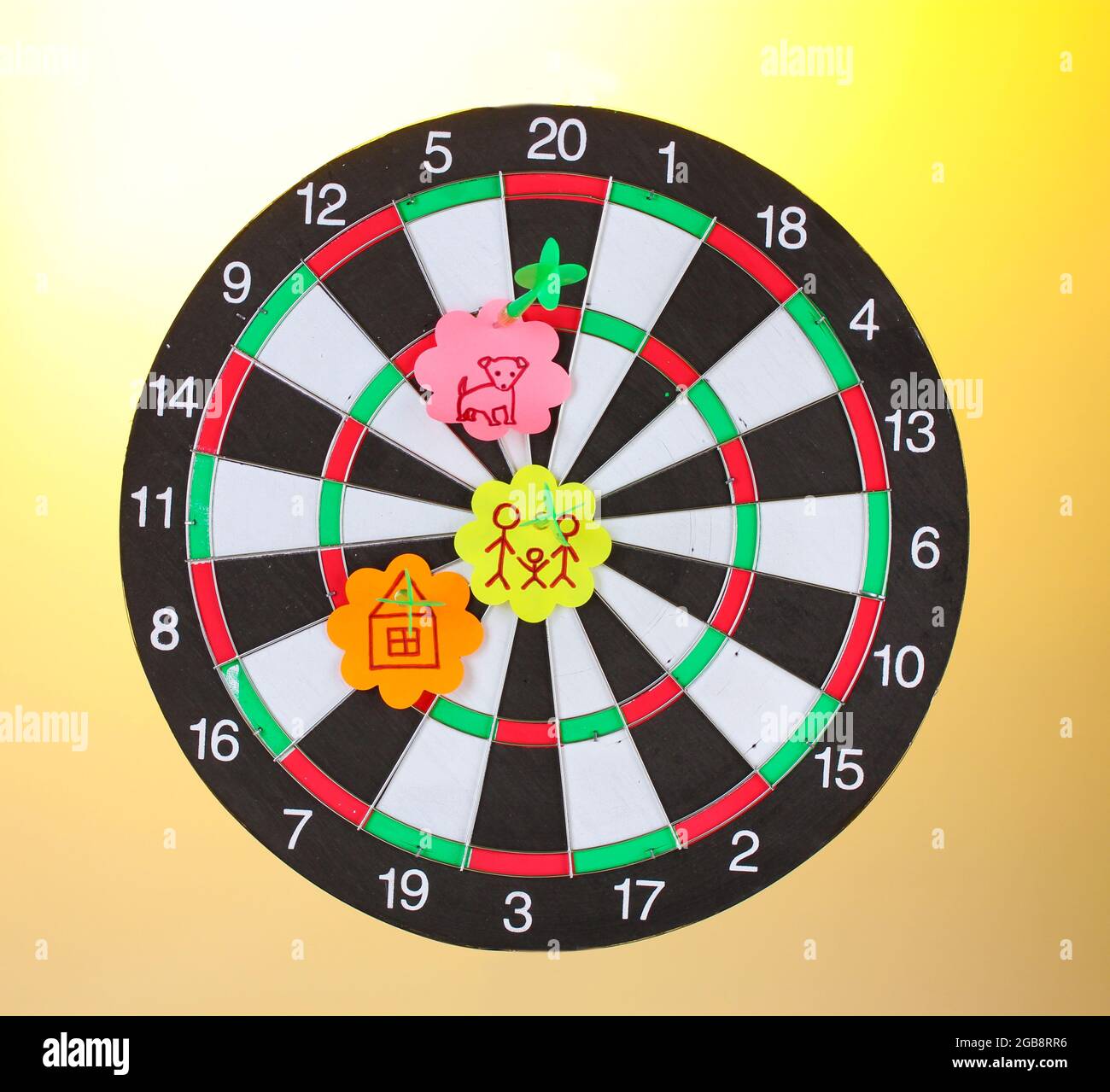 Darts with stickers depicting the life values on colorful background ...