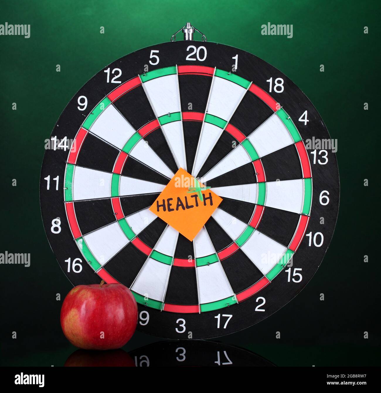 Darts with a sticker symbolizing health on colorful background Stock ...